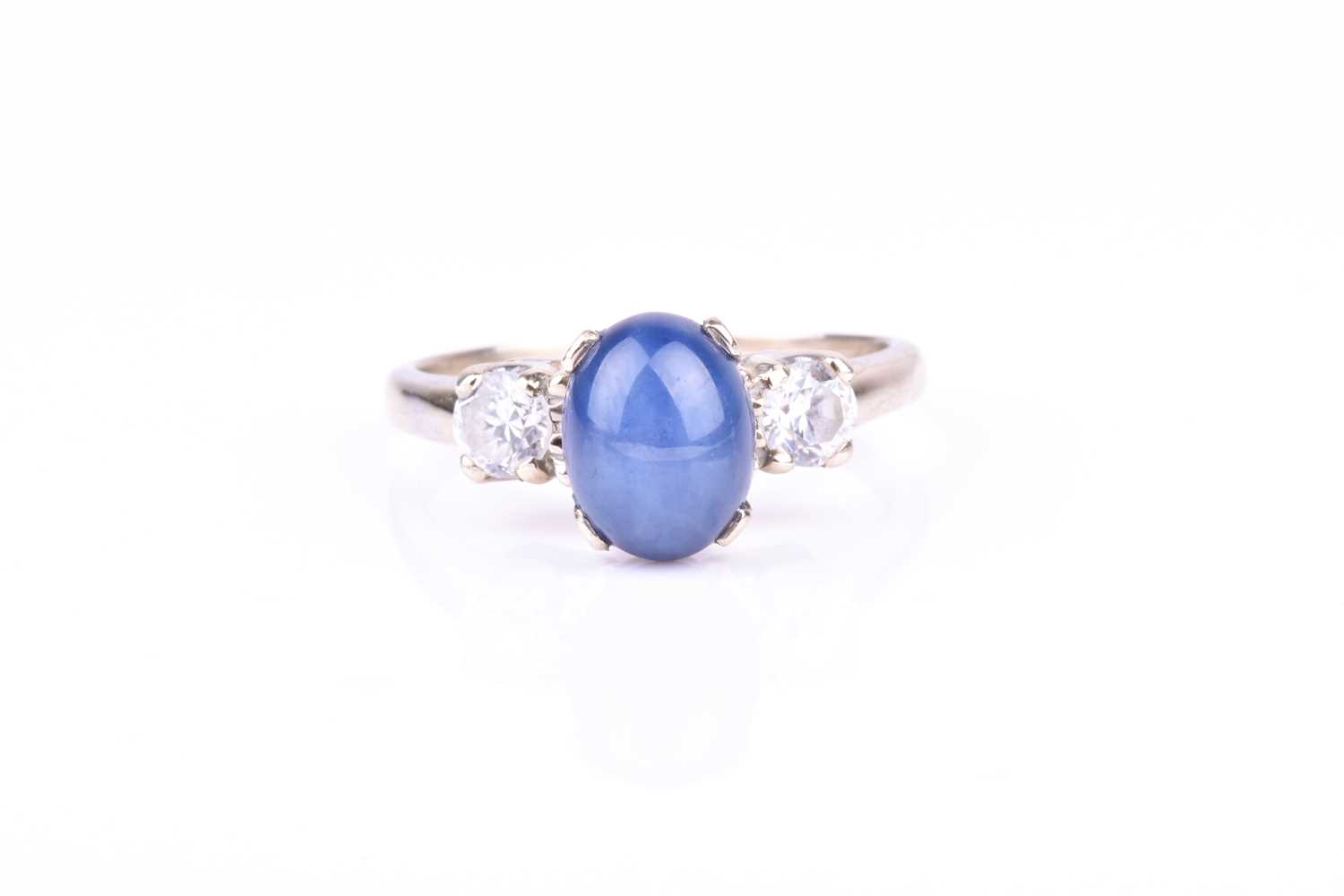 Lot 633 - A 14k white gold, star sapphire, and CZ ring