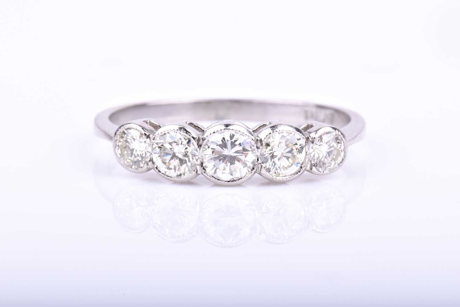 Lot 795 - A platinum and diamond ring millegrain set