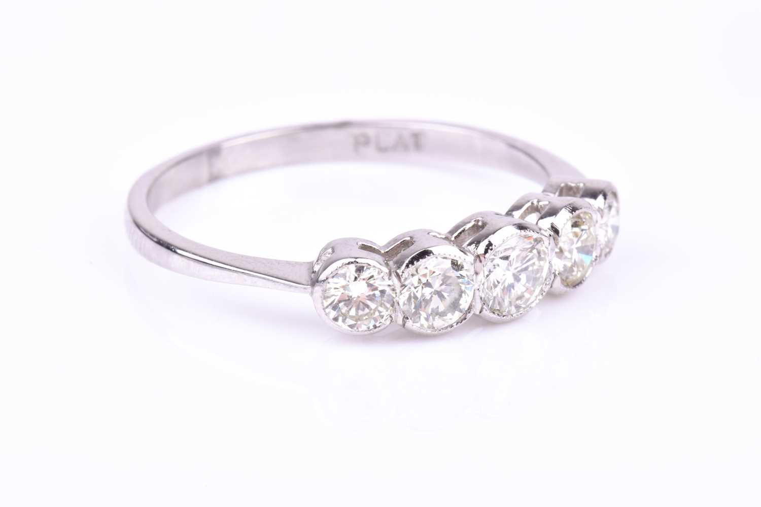 Lot 795 - A platinum and diamond ring millegrain set