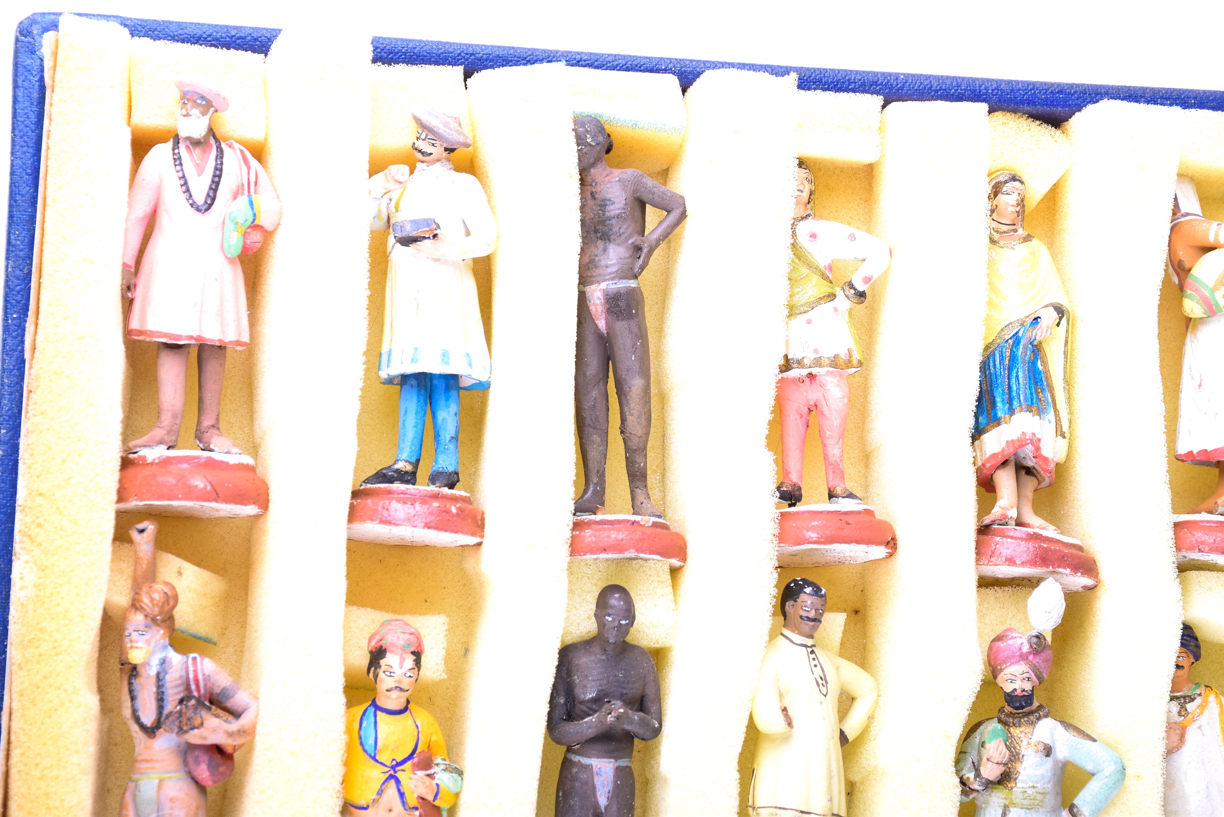 Lot 289 - a boxed collection of painted plaster Indian