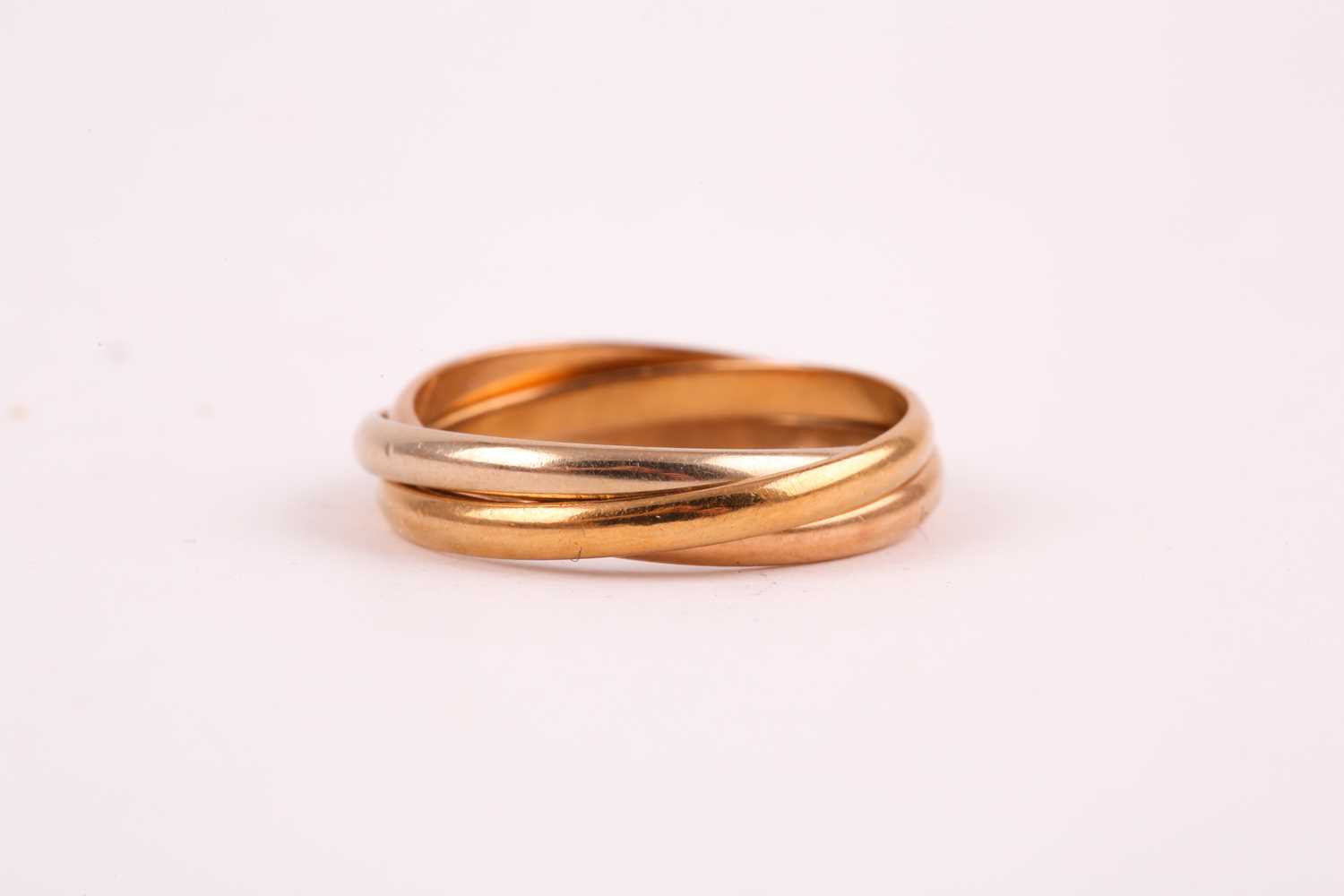 Lot 322 - A Cartier 'Trinity' three colour gold ring;