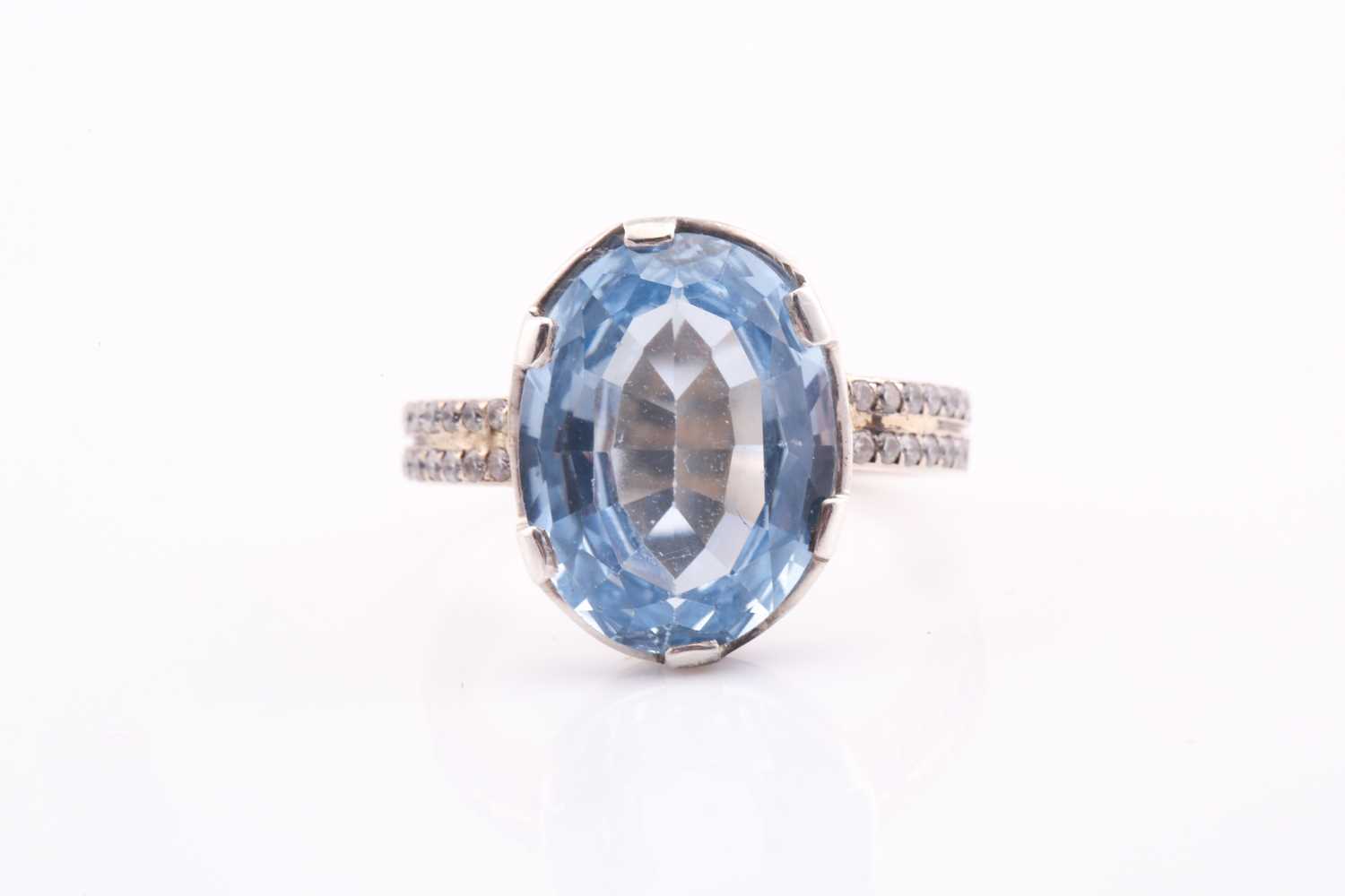 Lot 261 - A blue topaz and diamond ring, the oval