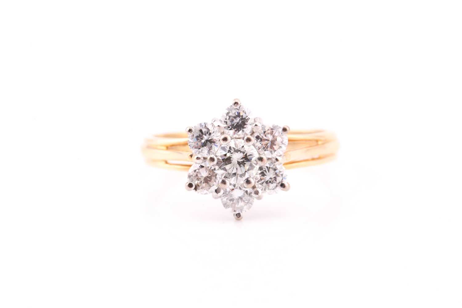 Lot 753 - A seven stone diamond cluster ring; the
