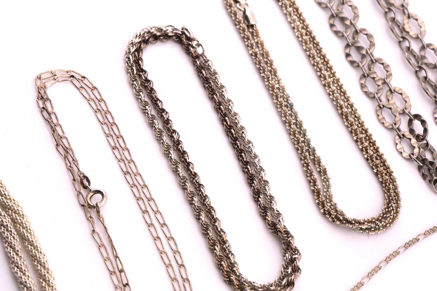 Lot 388 - Seven white metal chains and another gem-set