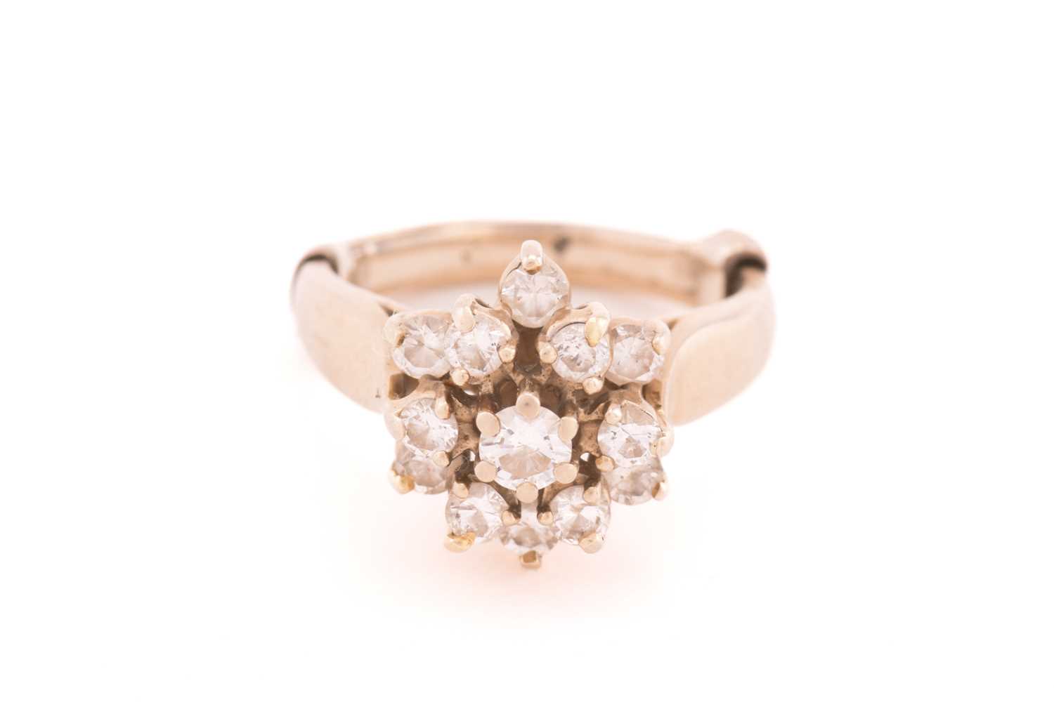 Lot 57 - A three-tier diamond cluster ring, consisting