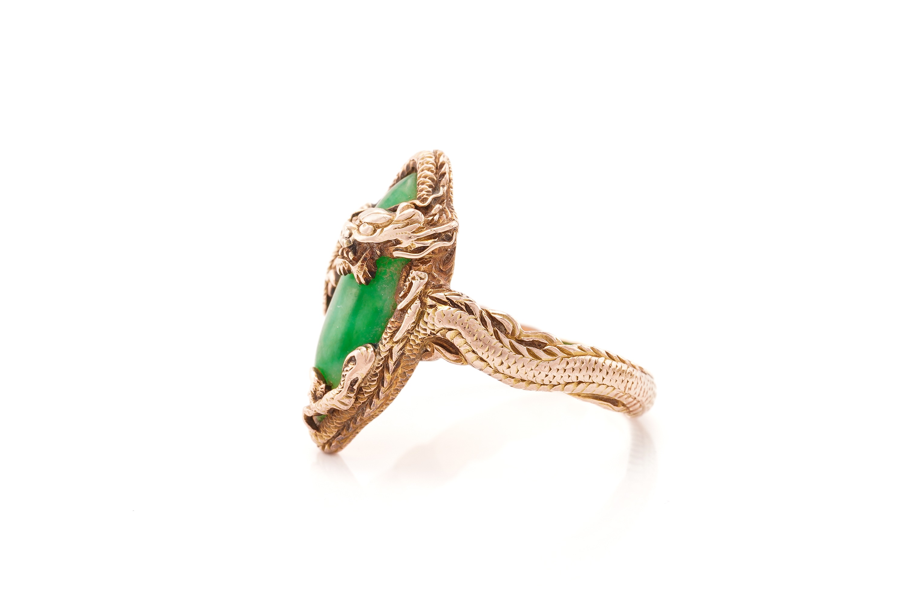 Lot 53 - A Chinese dragon ring set with green jade,