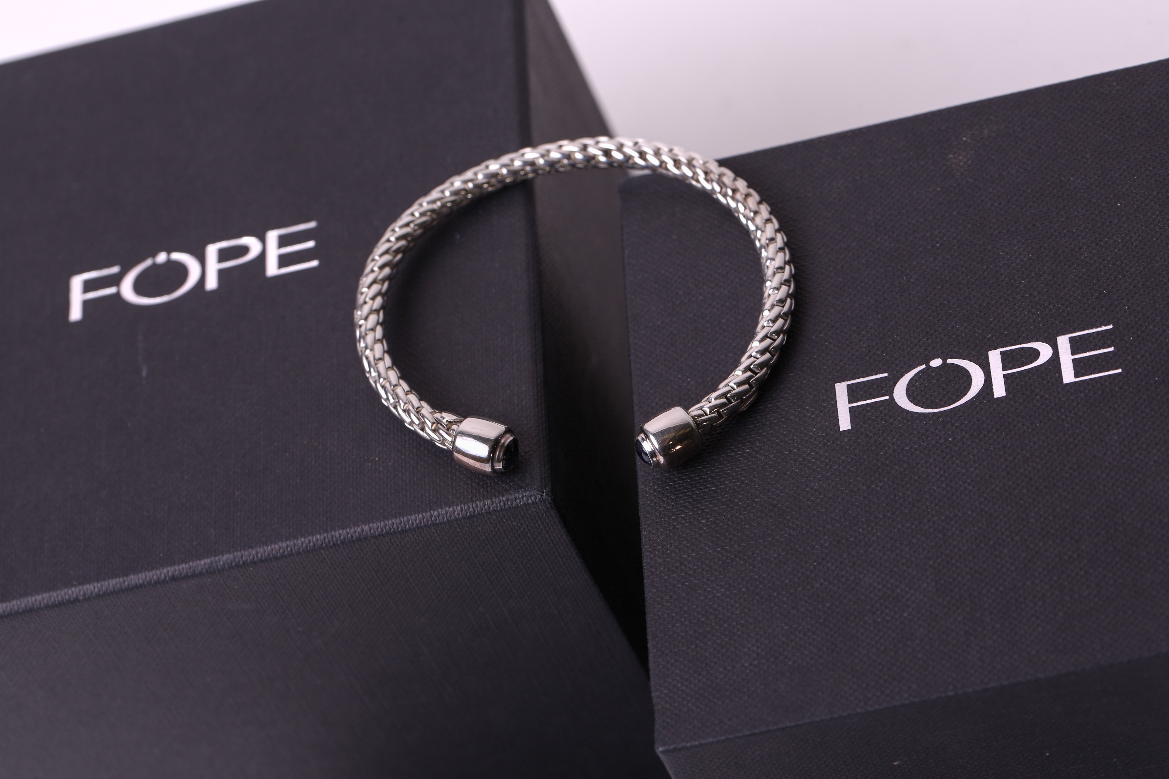 Lot 29 - FOPE - A Silver Fope bangle with sapphires
