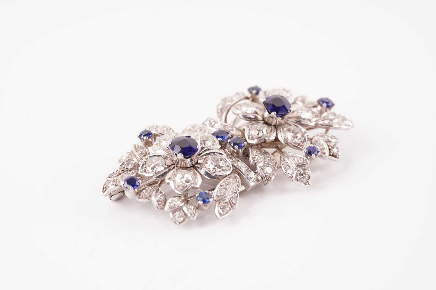Lot 43 - A floral duette brooch set with sapphires and