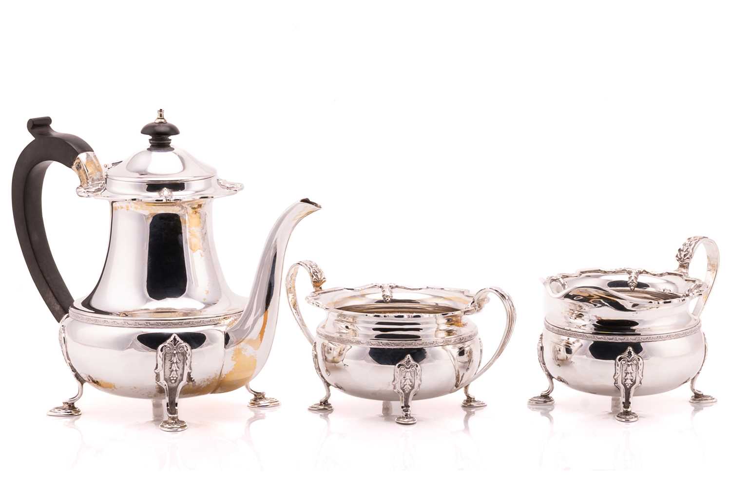 Lot 445 - A three piece silver coffee set; shaped