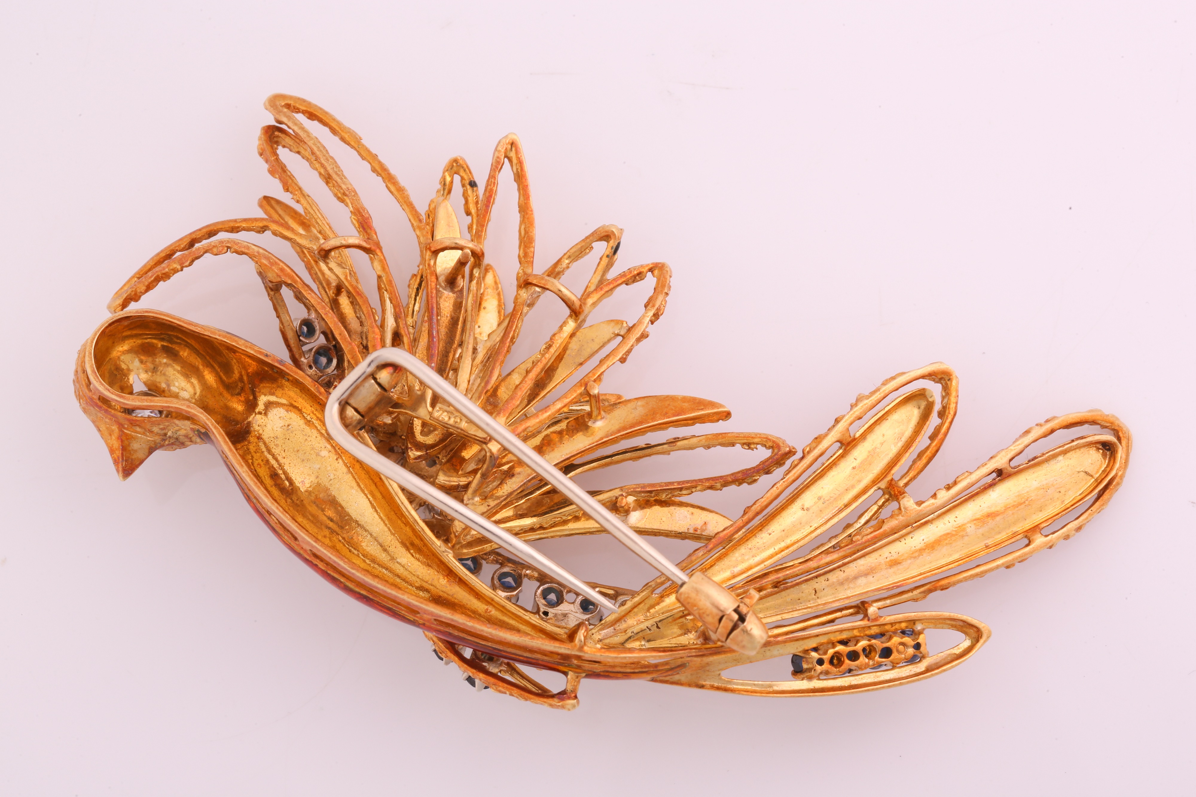 Lot 22 - A sapphire and diamond phoenix brooch set in