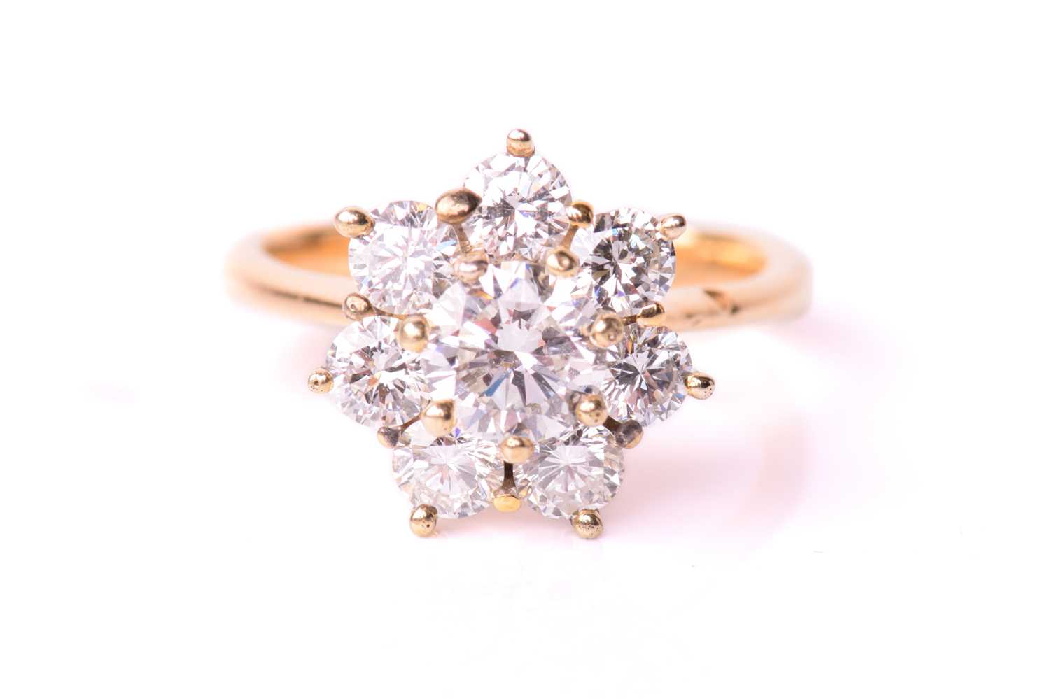 Lot 96 - A diamond cluster ring set in yellow metal,