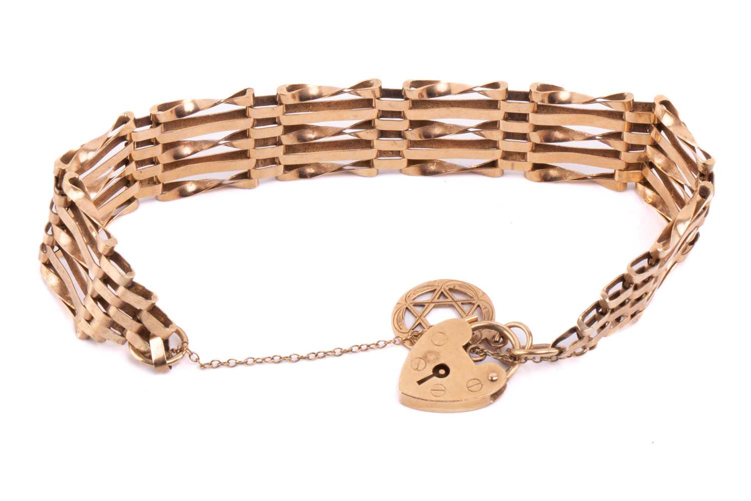 Lot 7 - A five-row gate link bracelet with charm in