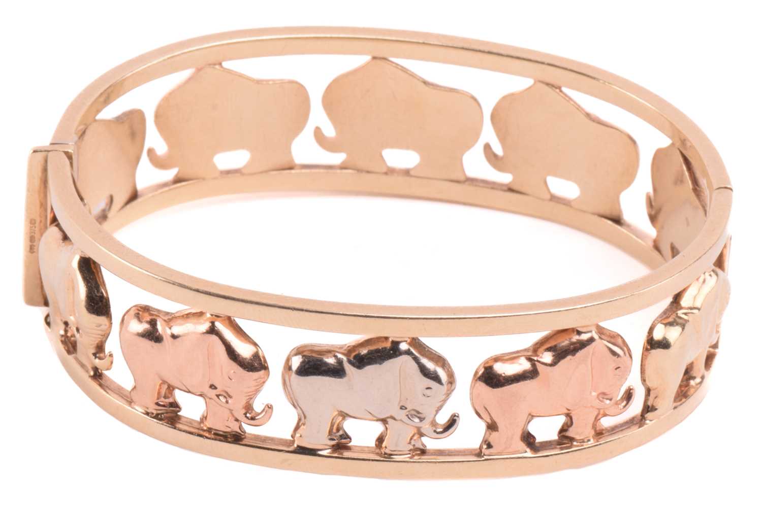 Lot 274 - A gold hinged bangle, with elephant motifs