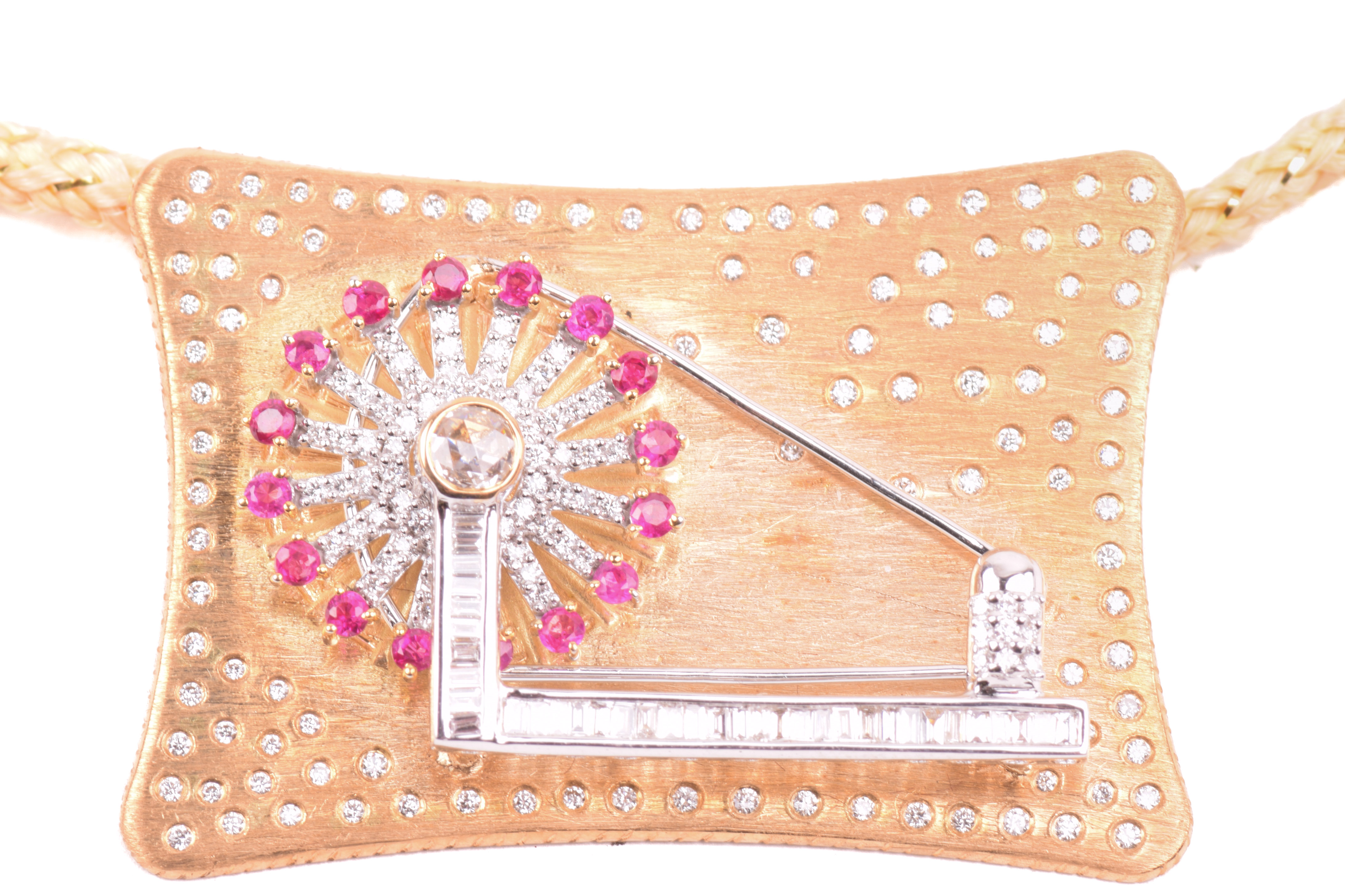 Lot 3 - An Indian spinning wheel pendant set with ruby