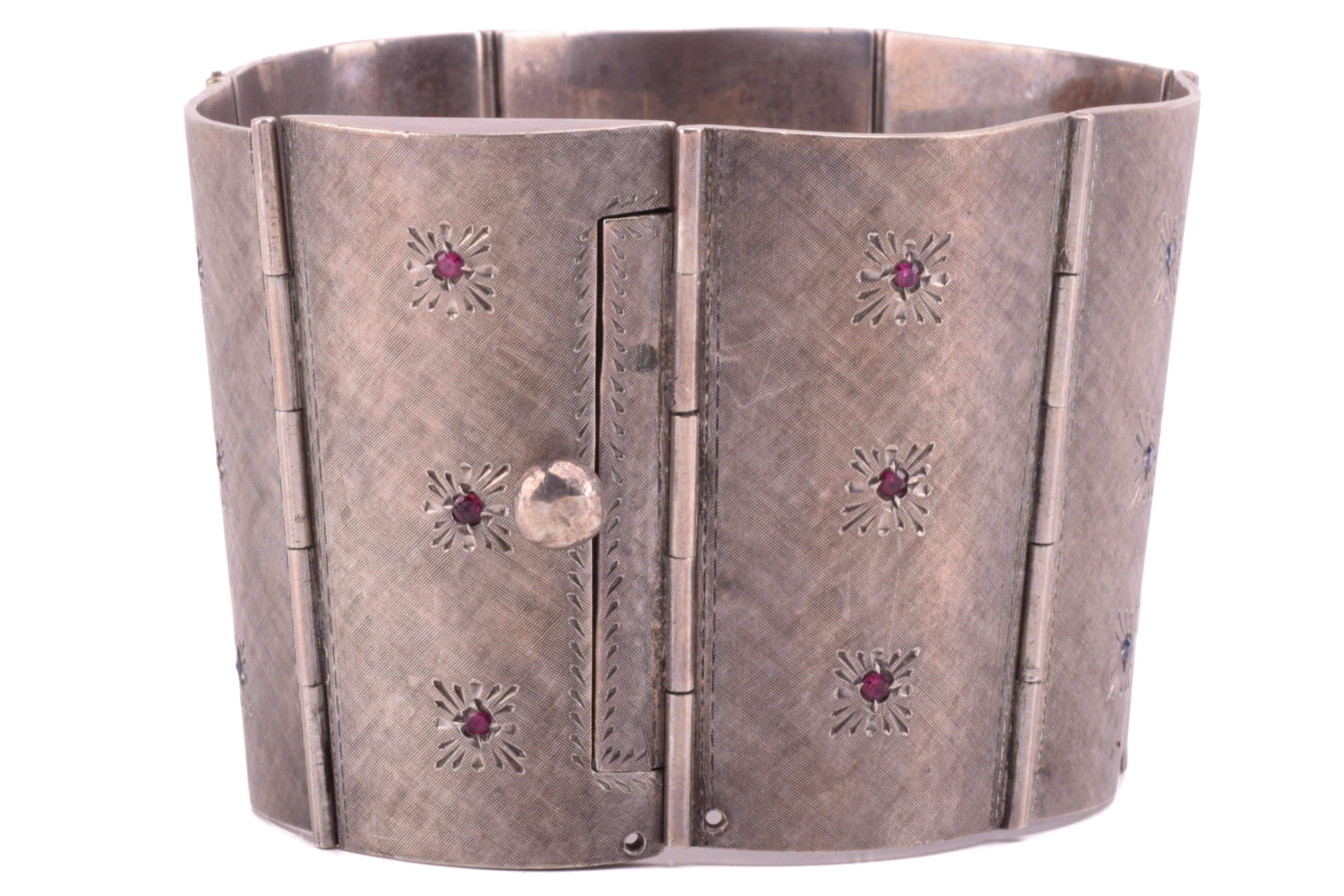 Lot 85 - A gem-set cuff bracelet by Dunhill,