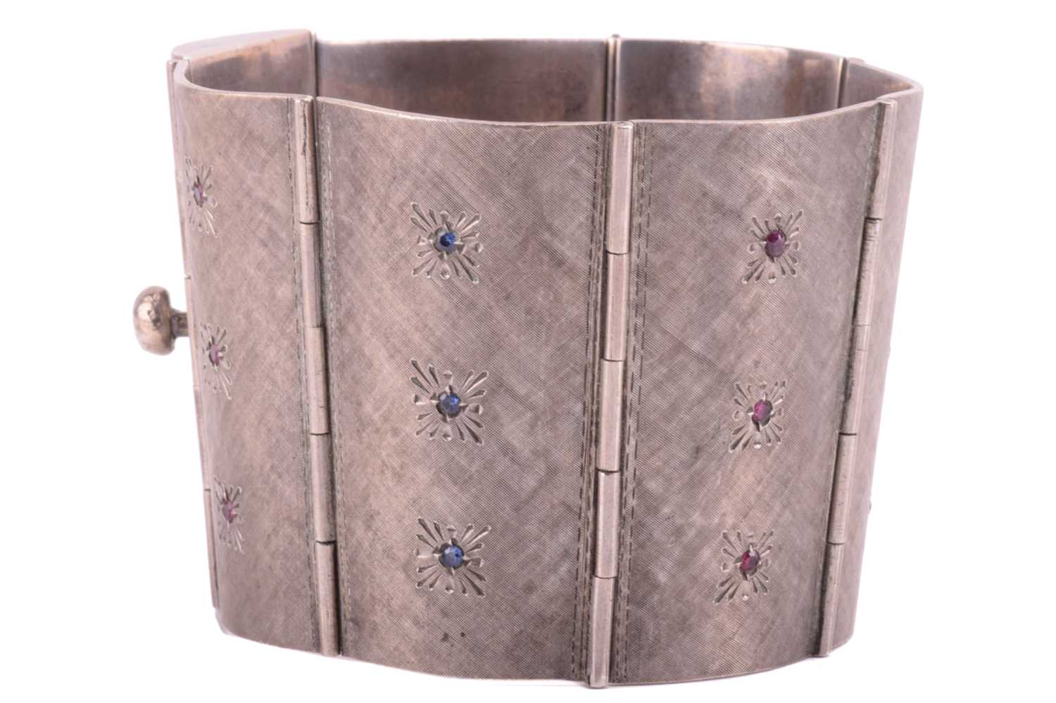 Lot 85 - A gem-set cuff bracelet by Dunhill,