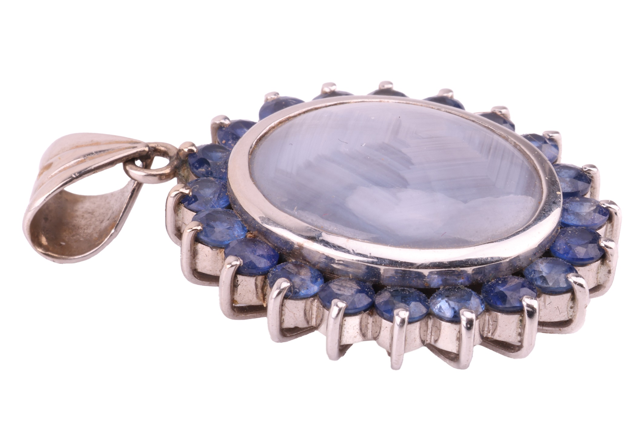 Lot 59 - A star sapphire halo pendant; comprising a