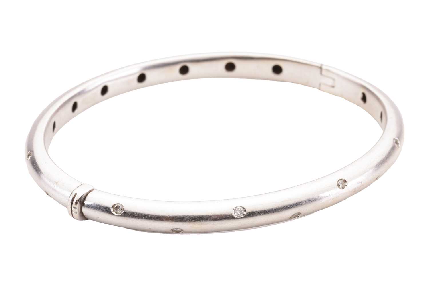 Lot 14 - A diamond-set hinged bangle, the court-shaped