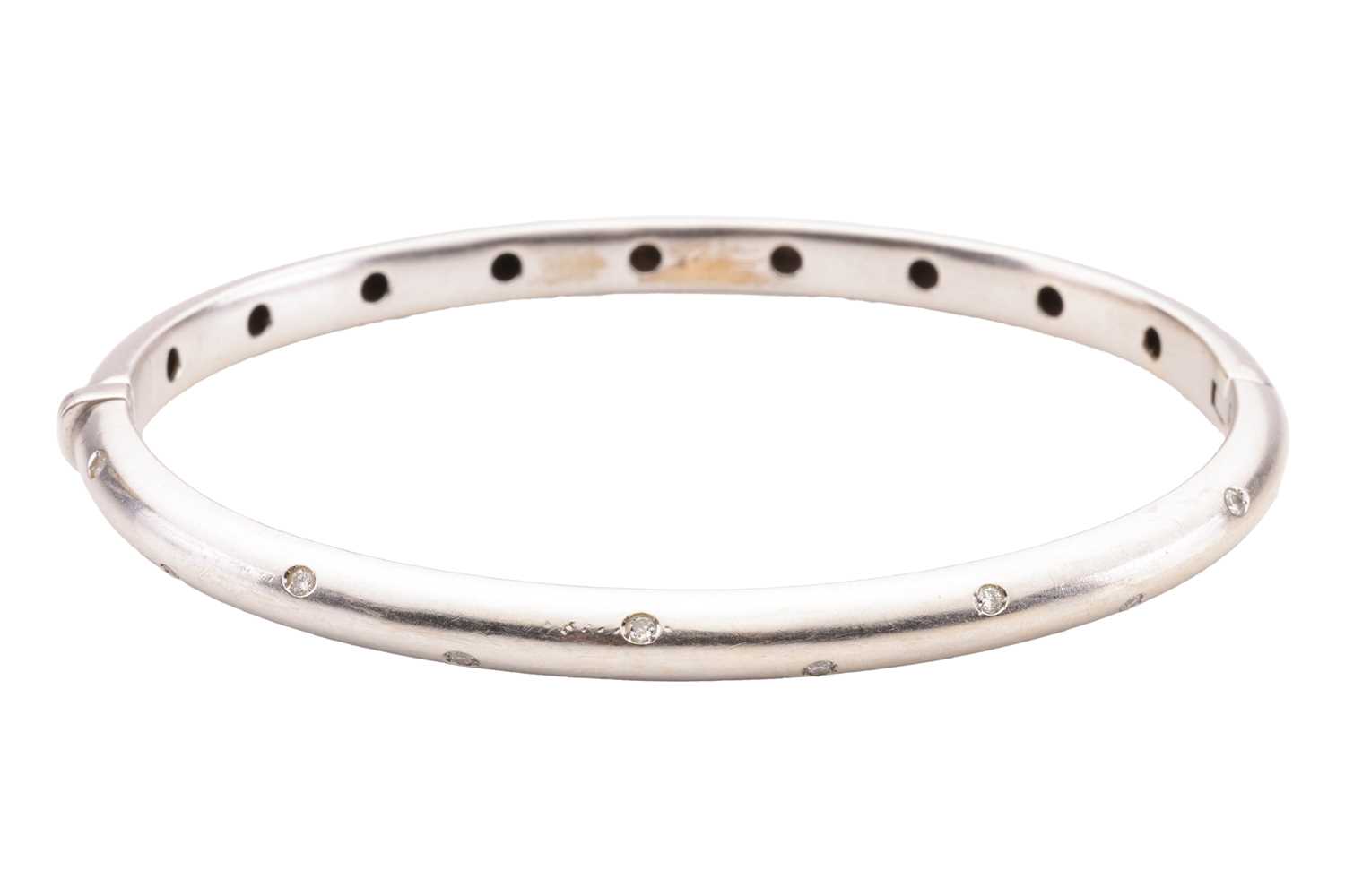 Lot 14 - A diamond-set hinged bangle, the court-shaped