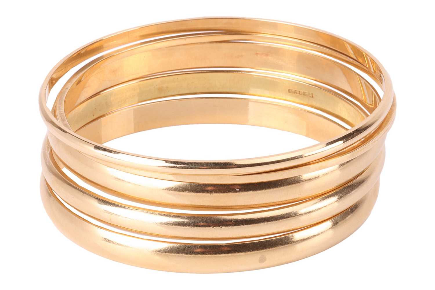 Lot 226 - Five closed bangles; to include four