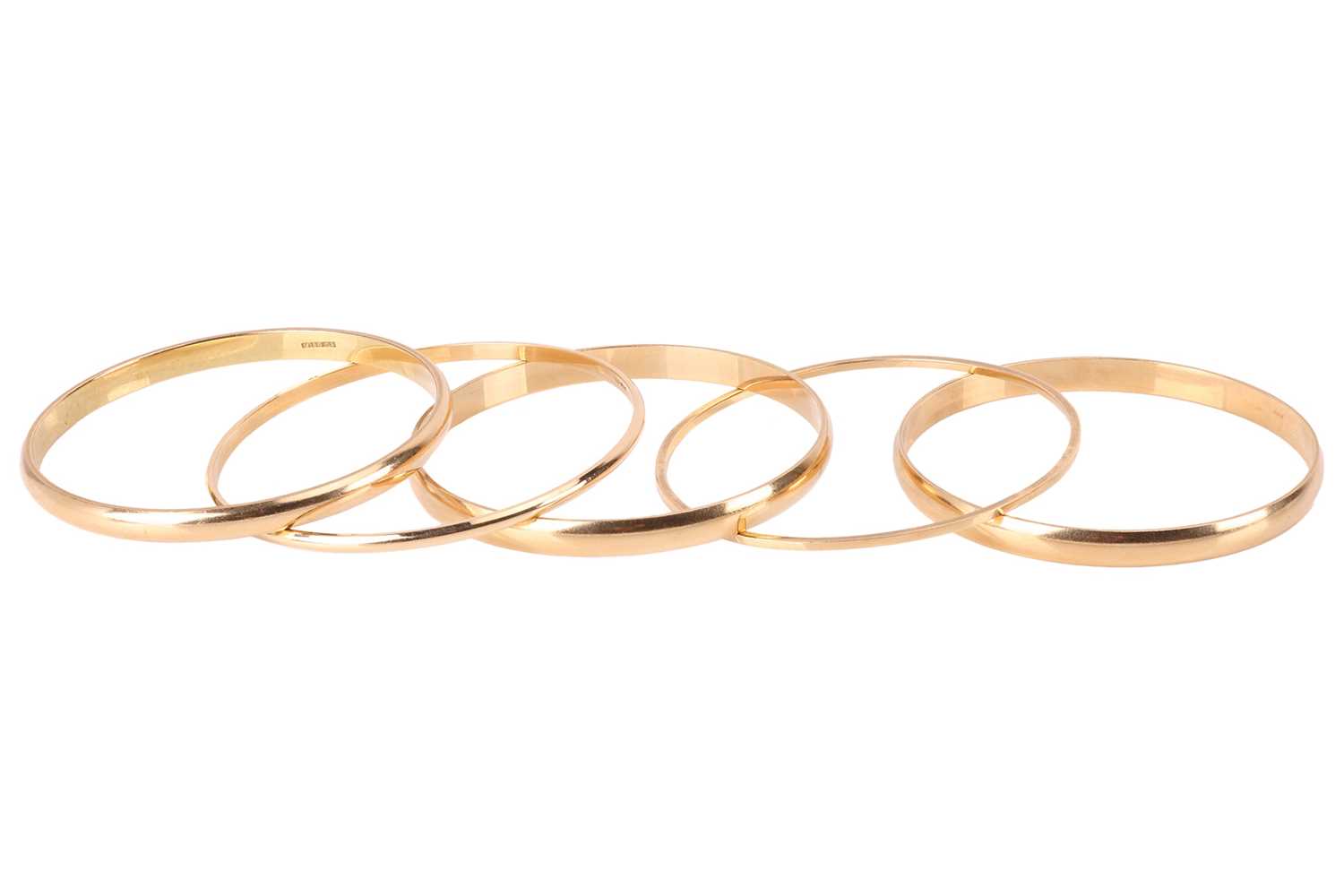 Lot 226 - Five closed bangles; to include four