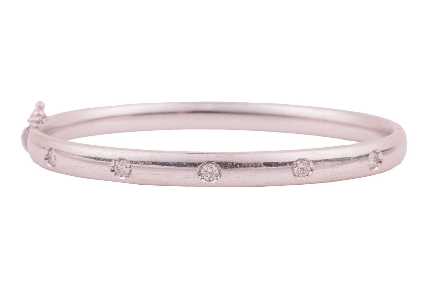 Lot 85 - A diamond-set hinged bangle, the court-shaped