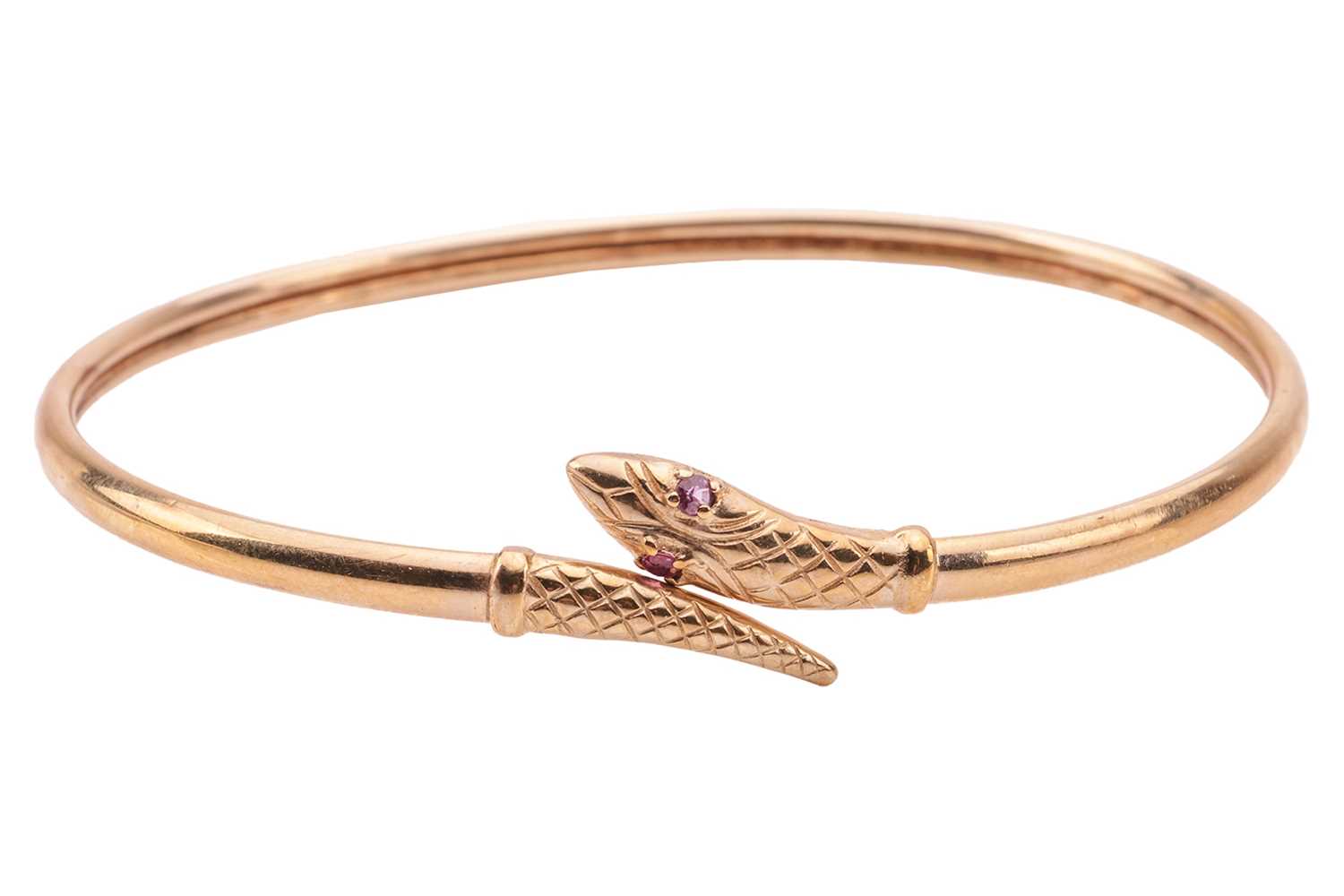 Lot 29 - A ruby-set snake bangle in 9ct gold,