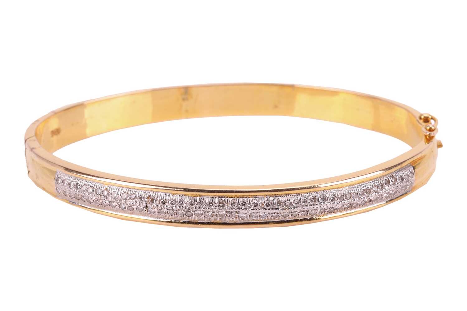 Lot 63 - A diamond-set hinged bangle, grain-set with