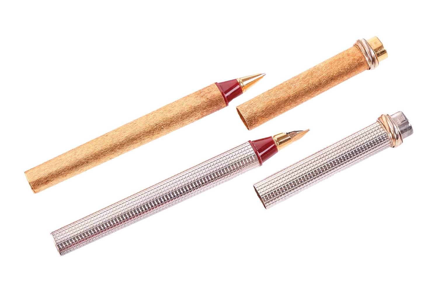 Lot 116 - A pair of Trinity pens by Cartier and four