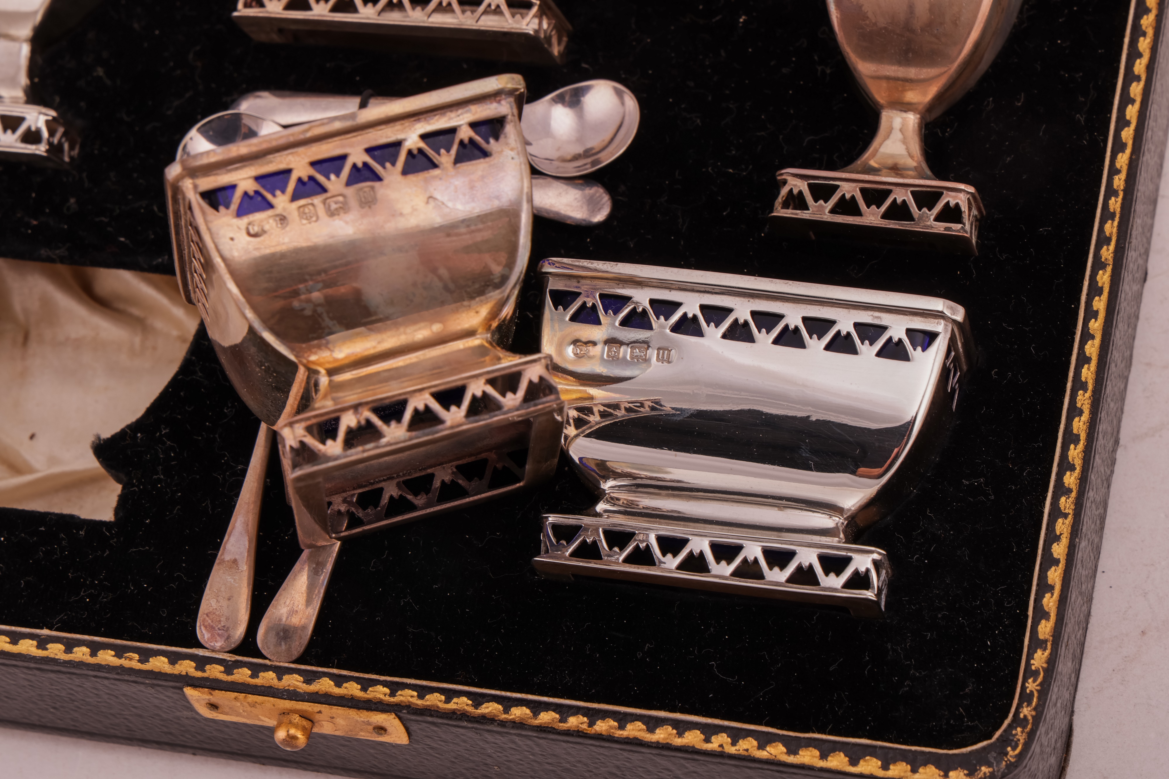 Lot 113 - A cased nine-piece silver table cruet set,